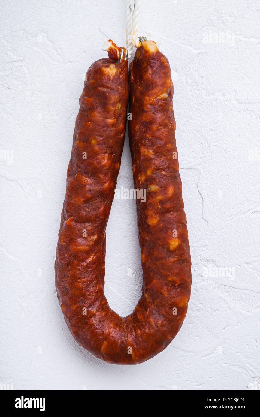 Dry cured chorizo sausage on white textured background Stock Photo - Alamy