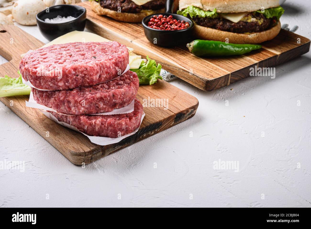 Raw ground beef meat cutlets for burger on white background with copy ...