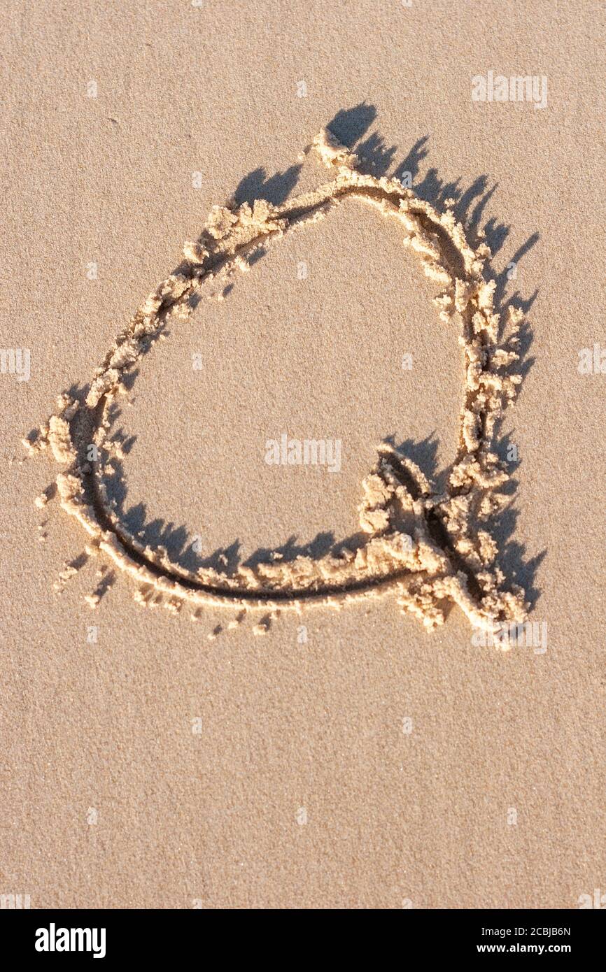 Q - Alphabet letter written on sand Stock Photo - Alamy