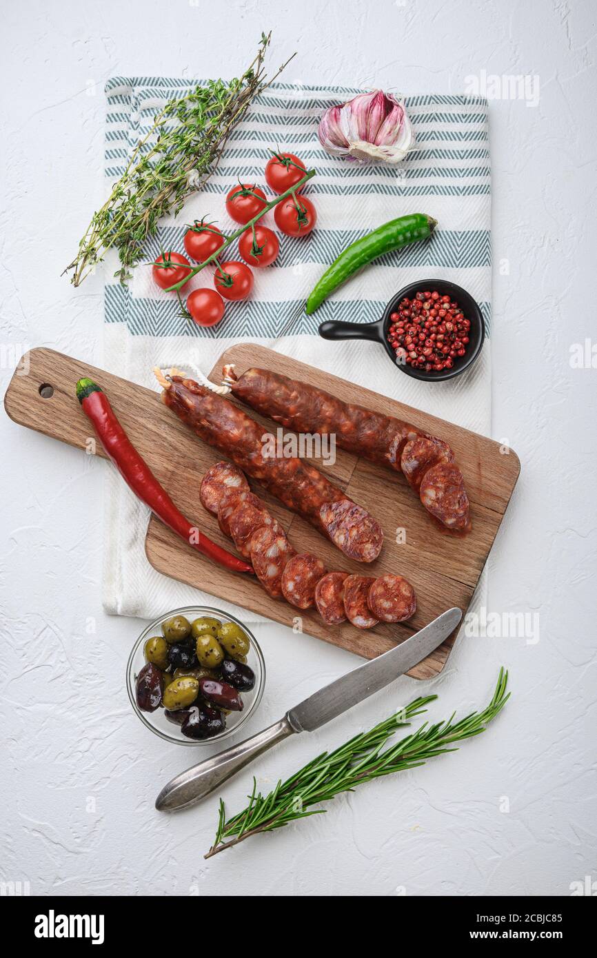 Traditional chorizo cuts with spices and ingredients on white textured ...