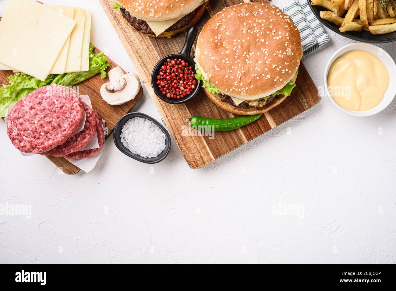 Burger with ingredients on white textured background with space for ...