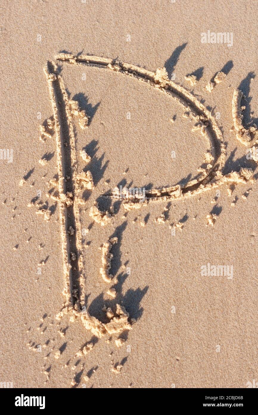 P - Alphabet letter written on sand Stock Photo - Alamy