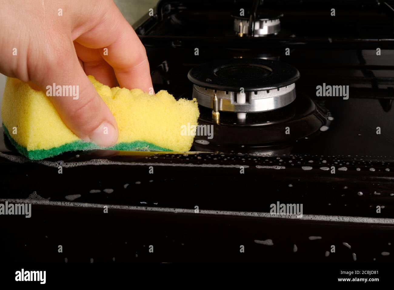 washing the gas stove with detergent and a washcloth close up Stock ...