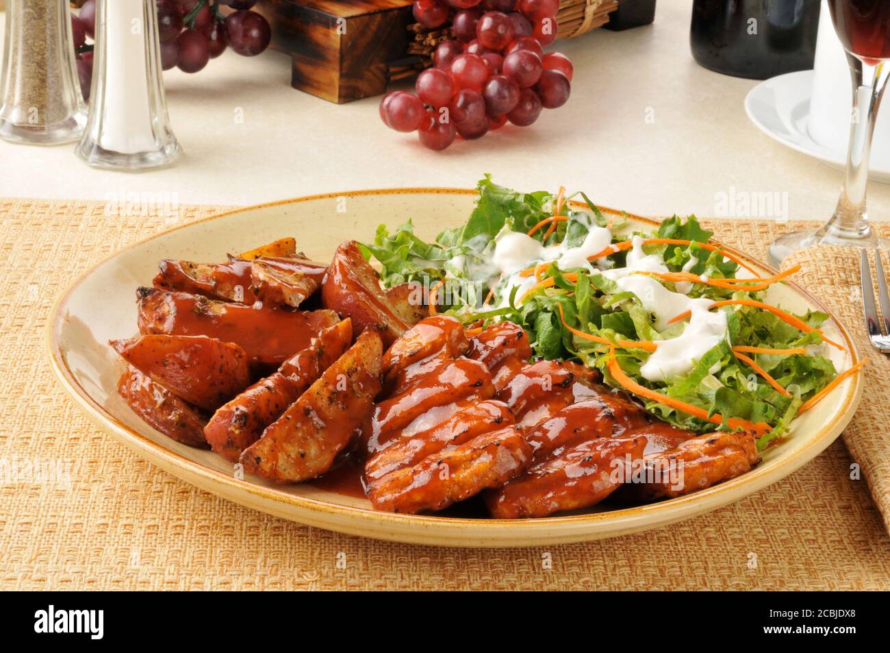 rib shaped barbecue pork cutlets with potatoes and salad Stock Photo ...