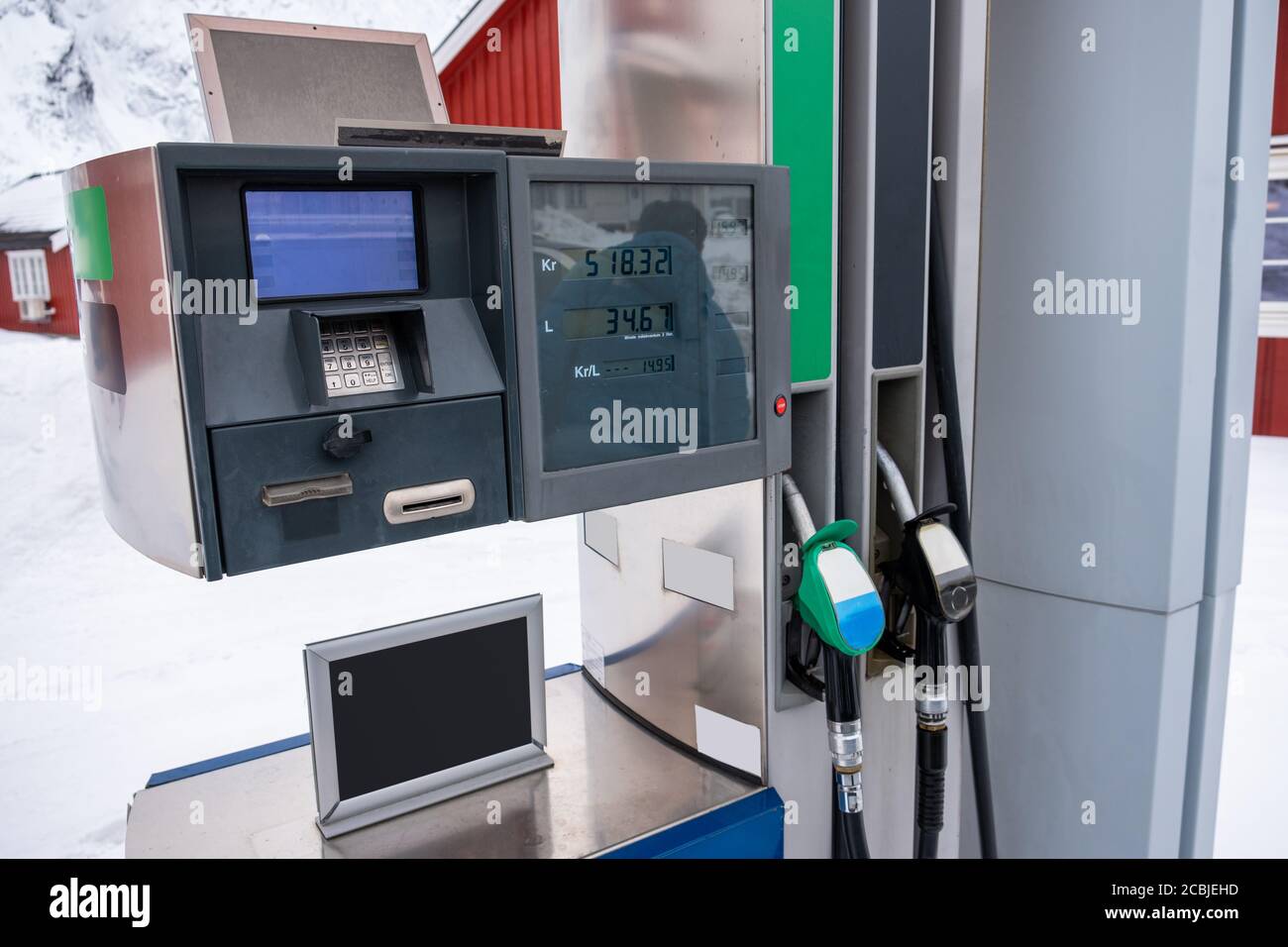 Fuel nozzle storage on petrol dispenser in gasoline station Stock Photo ...