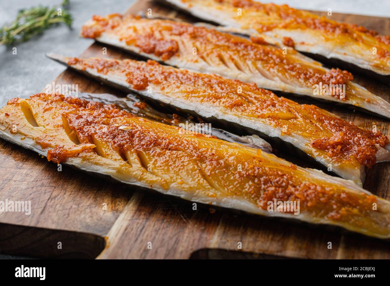 Marinated mackerel fillet with paprika and saffron on grey background ...