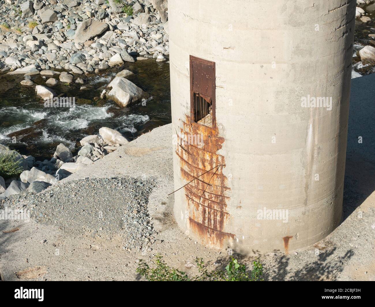 column of a reinforced concrete bridge over a river, with iron ...