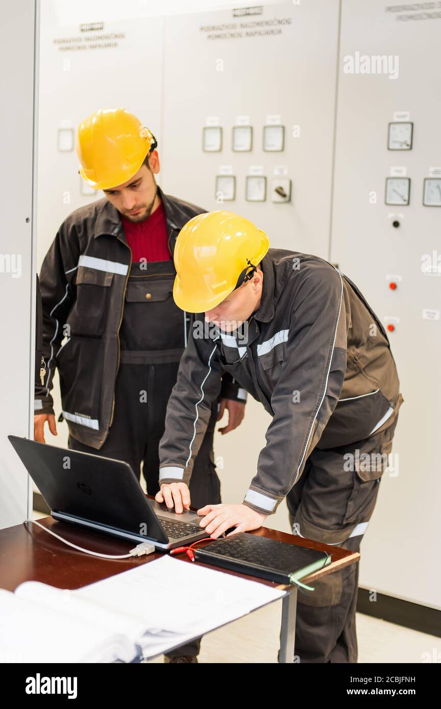 Field service crew engineers inspect relay protection system with ...