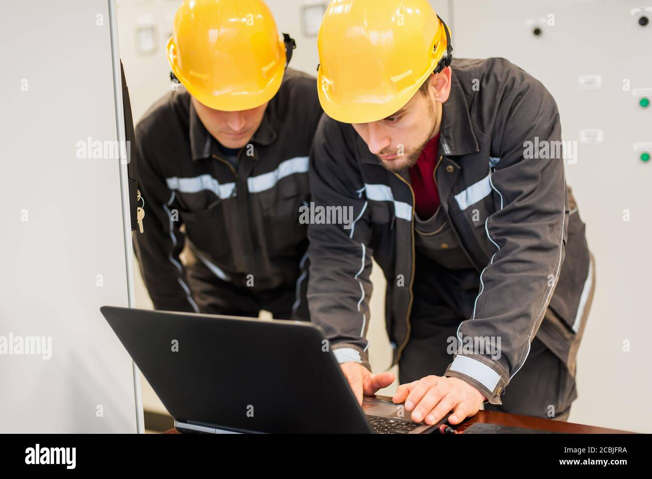 Field service crew engineers inspect relay protection system with ...