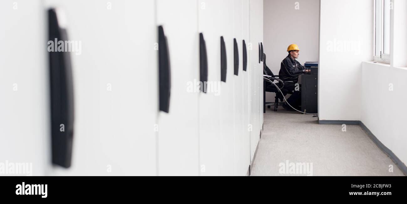 Maintenance engineer inspect relay protection system with laptop ...