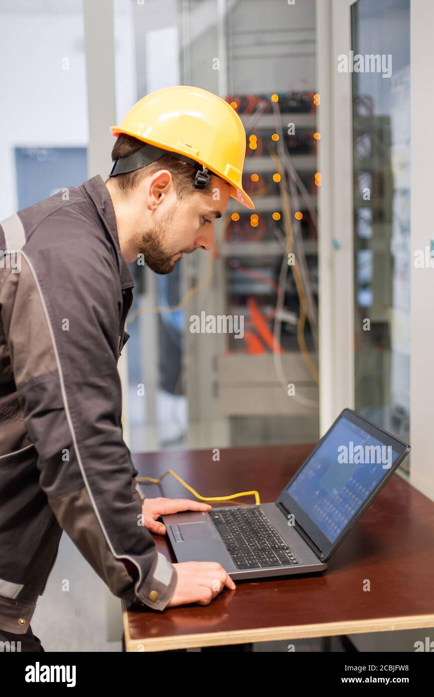 Maintenance engineer inspect relay protection system with laptop ...
