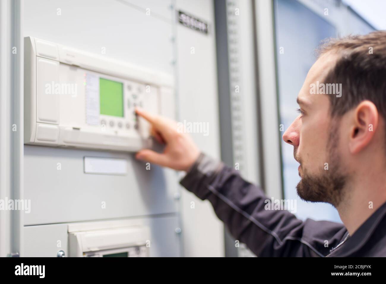 Maintenance engineer testing medium voltage switchgear and bay control ...