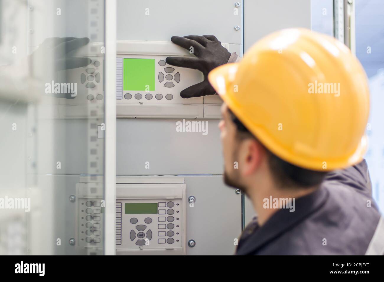 Maintenance engineer testing medium voltage switchgear and bay control ...