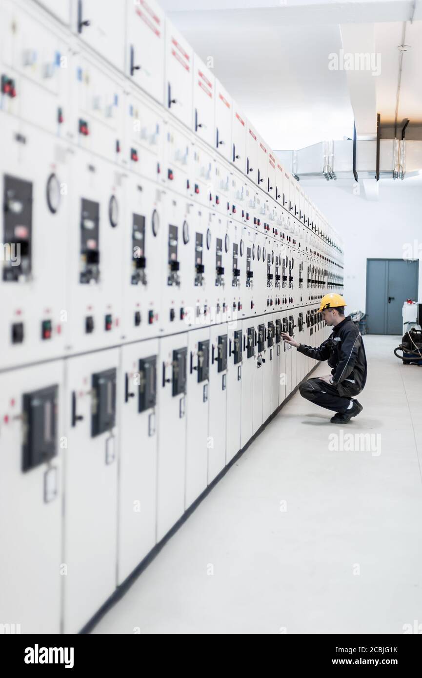 Maintenance engineer testing medium voltage switchgear and bay control ...