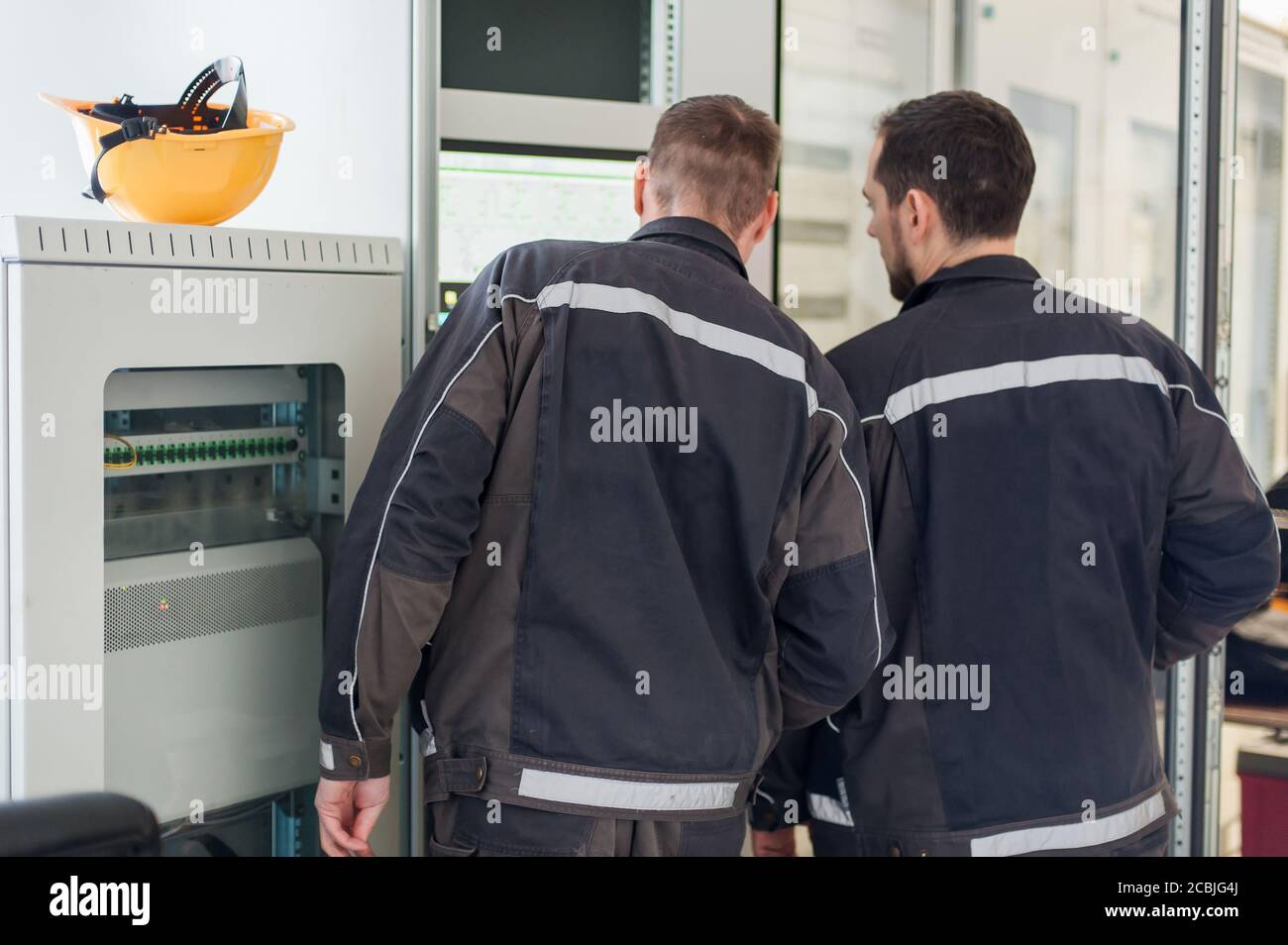 Two maintenance engineer work on relay protection system. Bay control ...