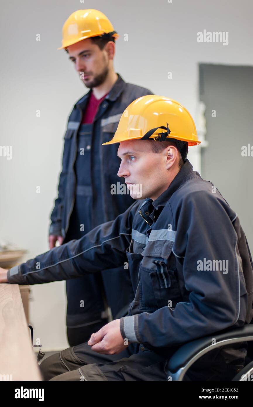 Two maintenance engineer work on relay protection system. Bay control ...