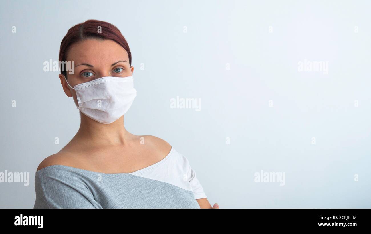 Caucasian woman with white medical mask on her face. Negative space or ...