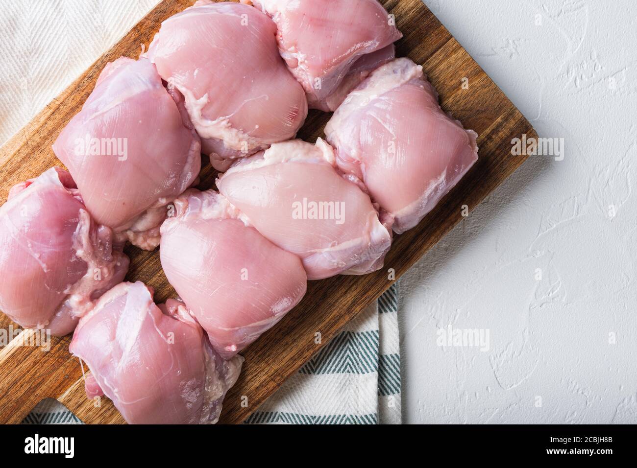 Raw skinless chicken meat on white background, flat lay with copy space ...