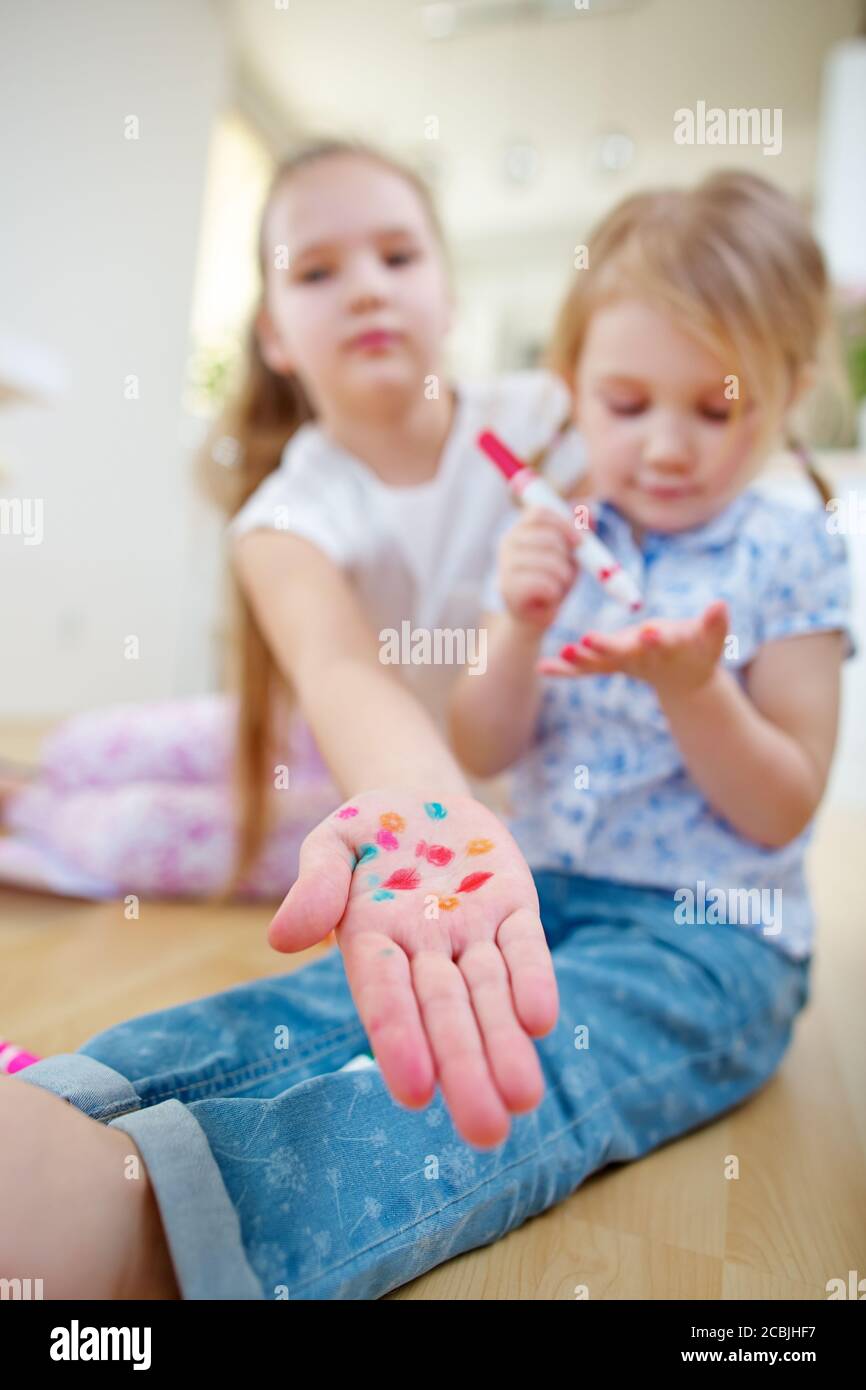 Child shows colorful stains on the hand from different felt-tip pens ...