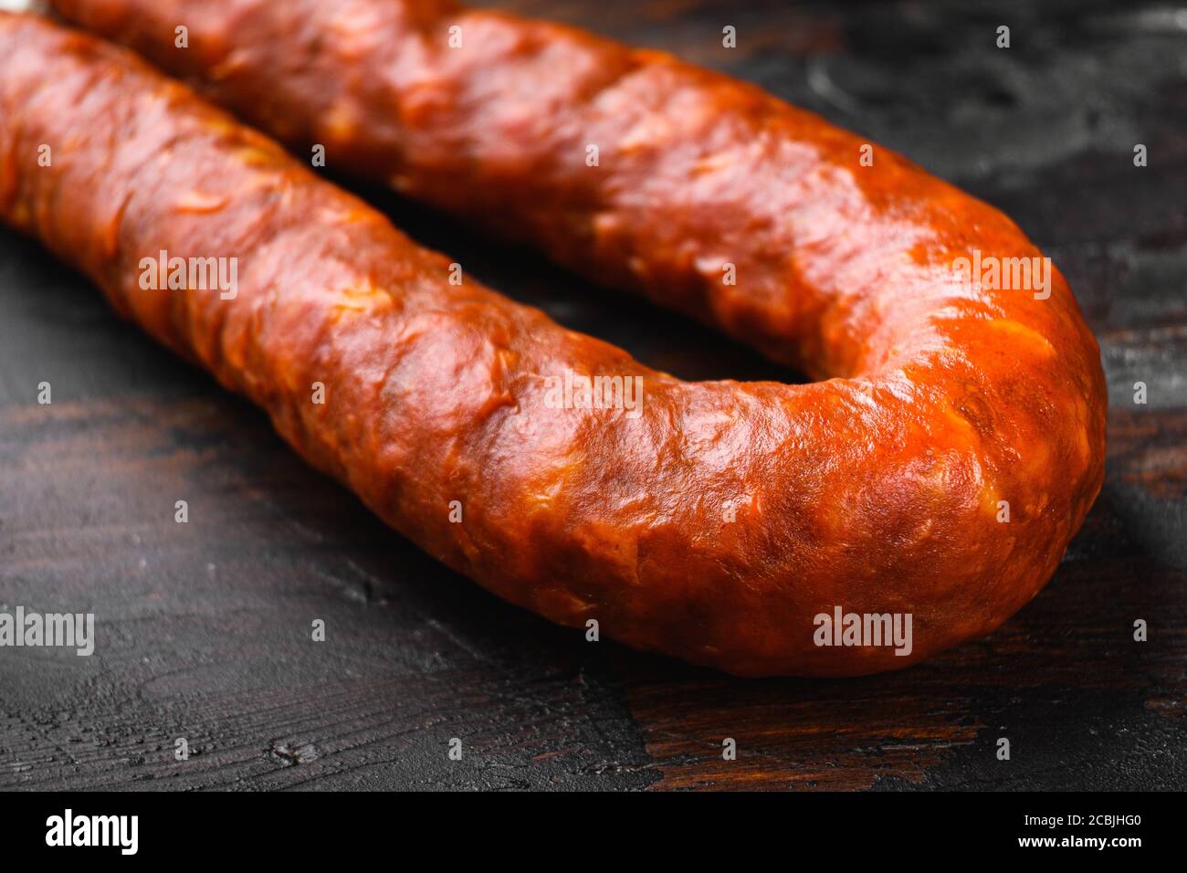 Traditional spanish chorizo sausage on old wooden table Stock Photo - Alamy