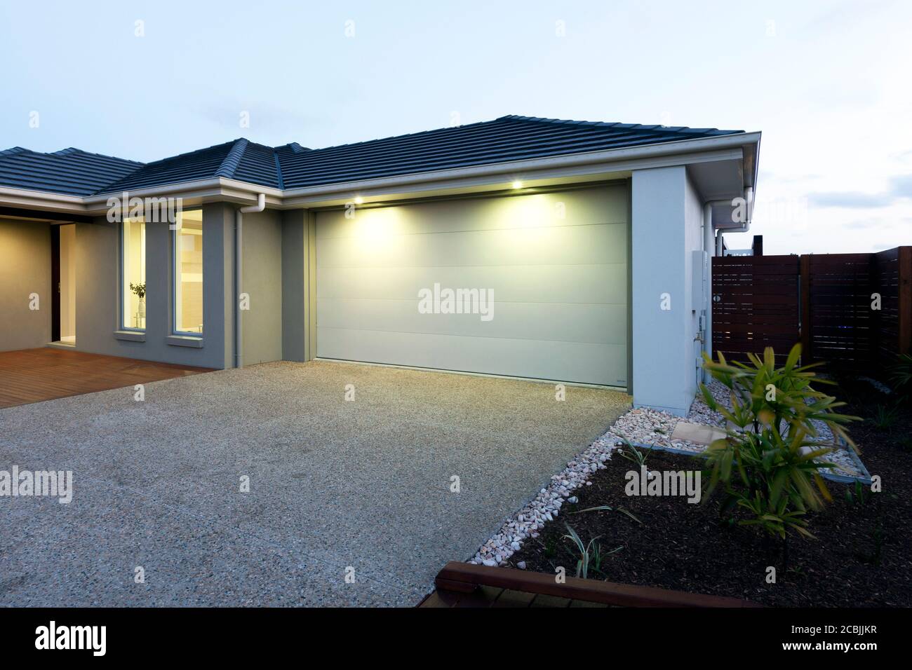 Fron view of a modern house with garage Stock Photo - Alamy