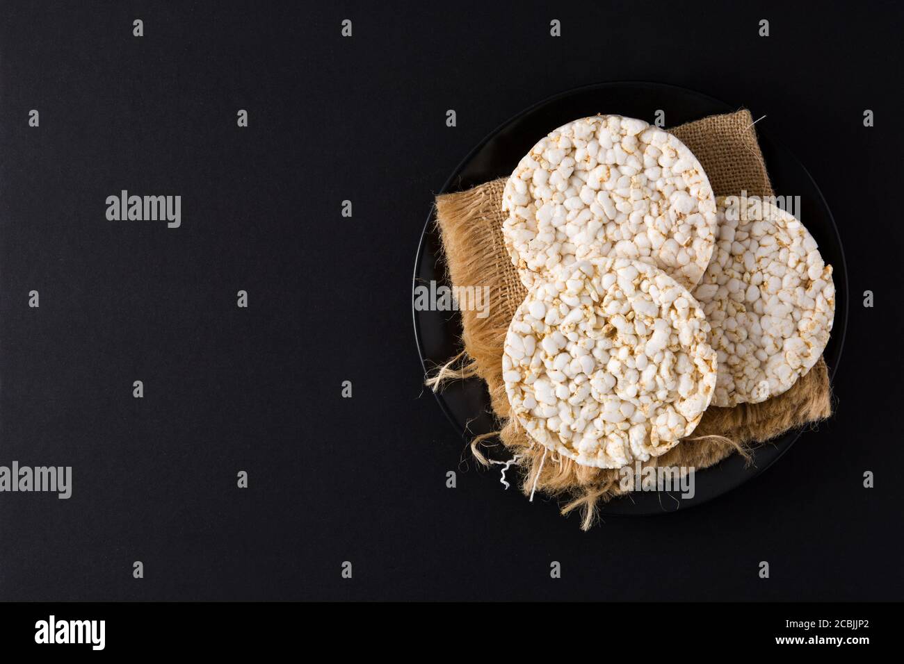 Puffed rice cakes on black background Stock Photo - Alamy