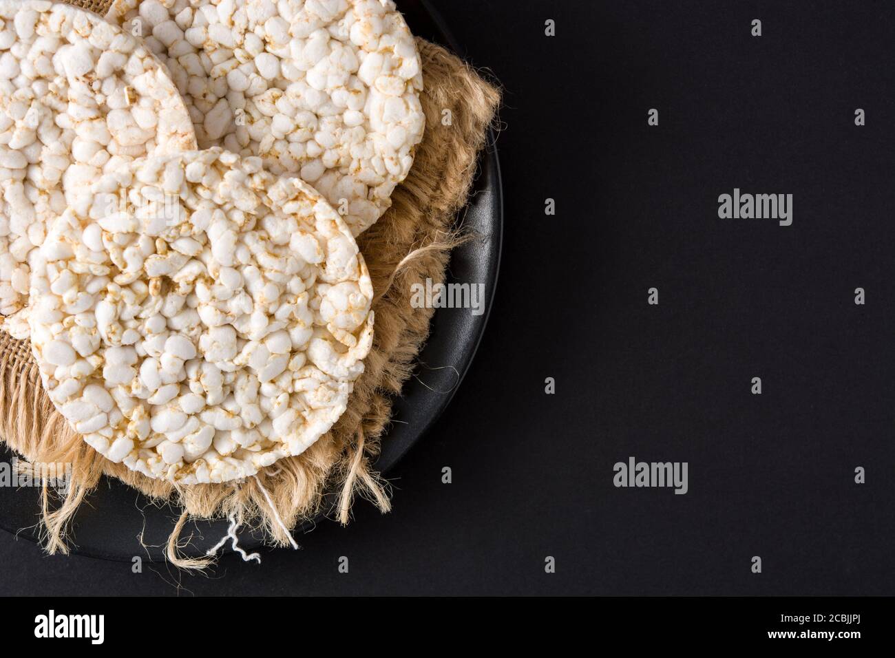 Puffed rice cakes on black background Stock Photo - Alamy