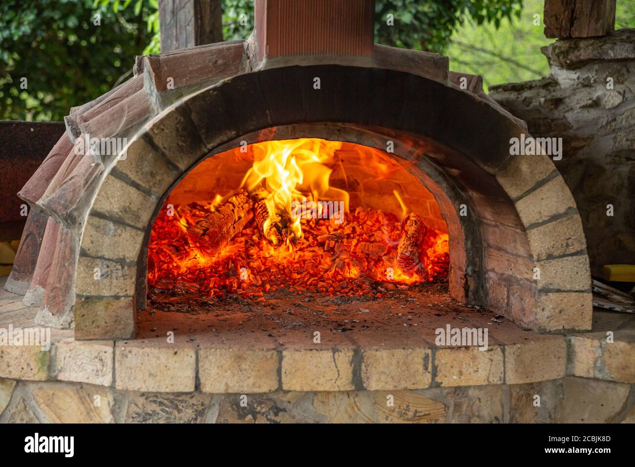 Burning oak wood in a furnace. Stove in country house. Bright flame ...