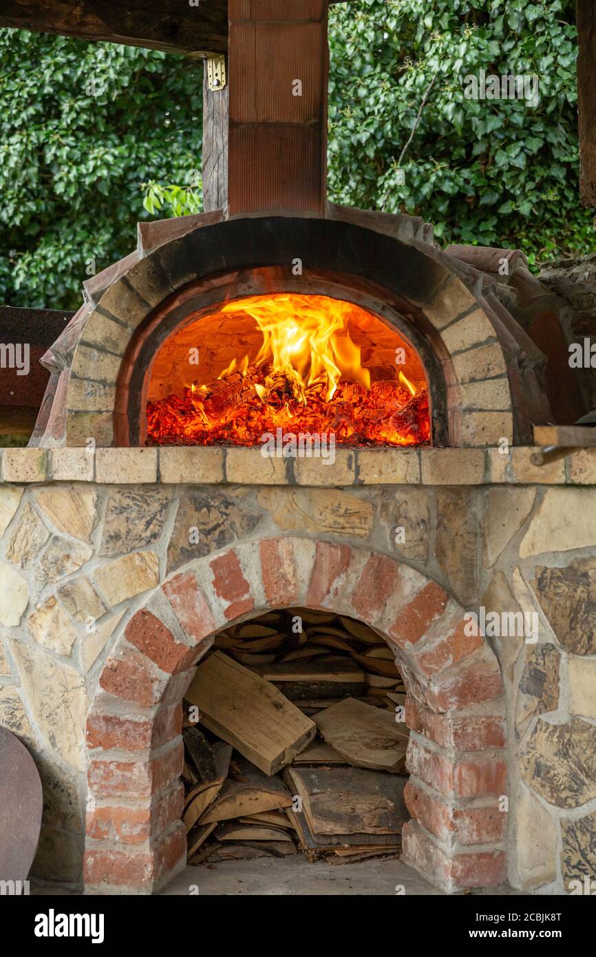 Burning oak wood in a furnace. Stove in country house. Bright flame ...