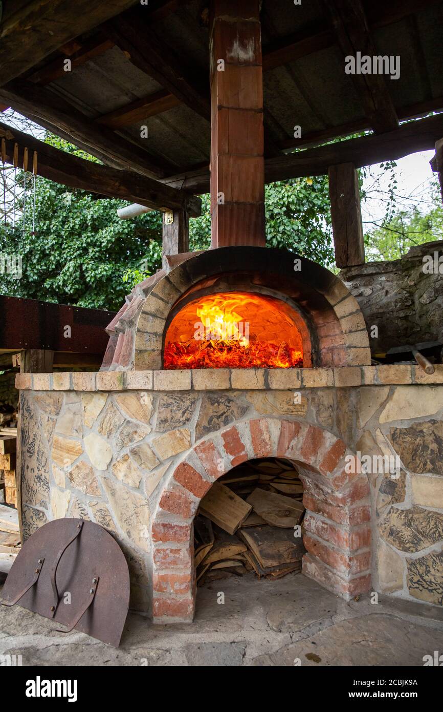 Burning oak wood in a furnace. Stove in country house. Bright flame ...