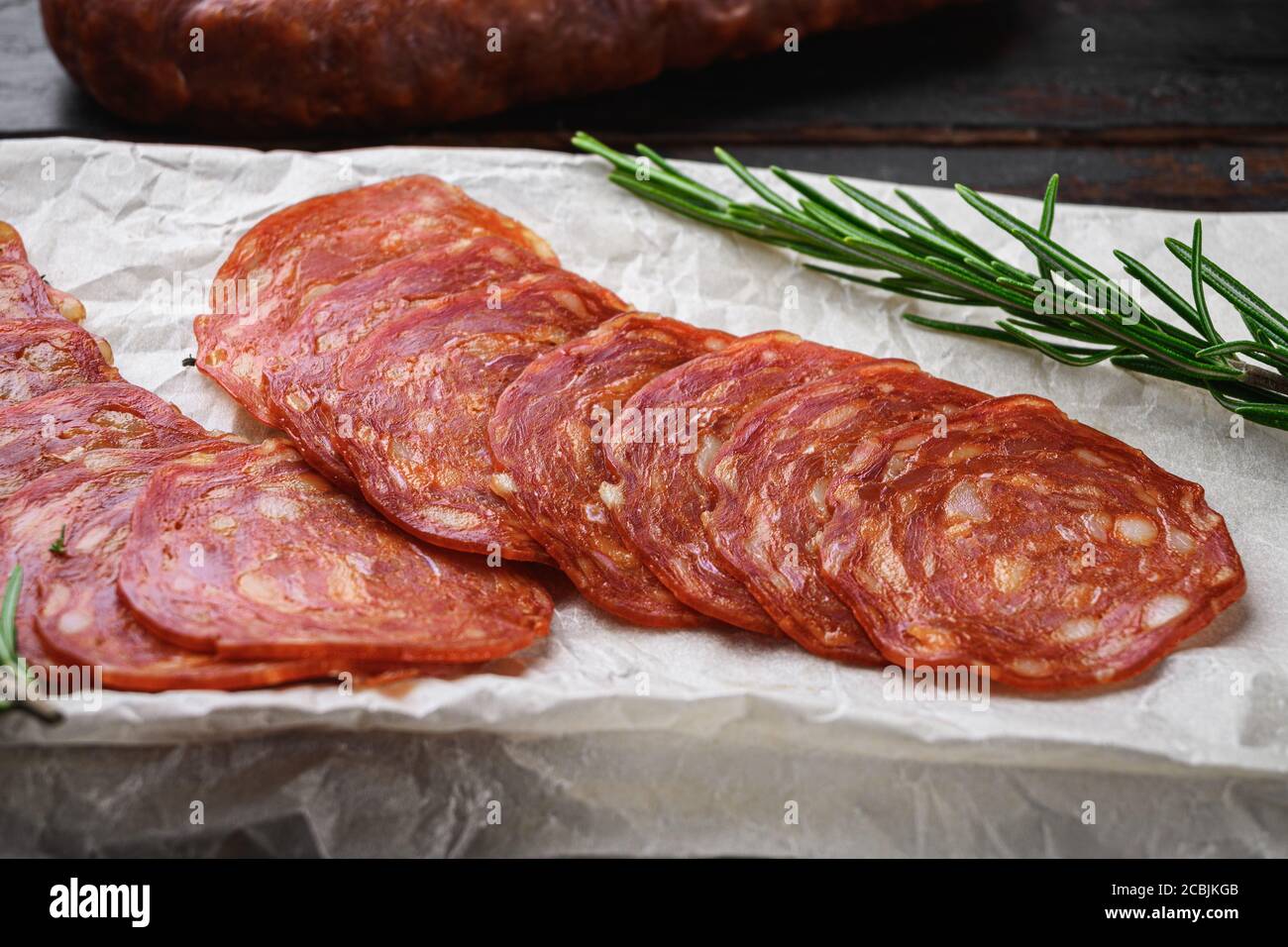 Chorizo, spanish traditional sausage cut to slices on dark wooden ...