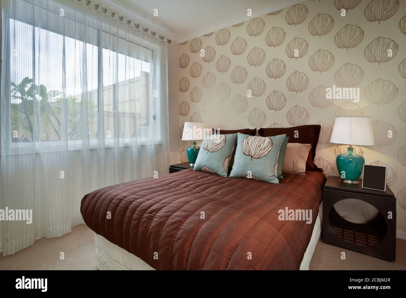 A brown queen size bed and bedroom Stock Photo - Alamy