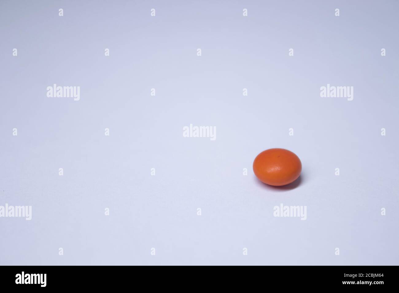 orange tablet - pill on a white background. medicine and disease ...