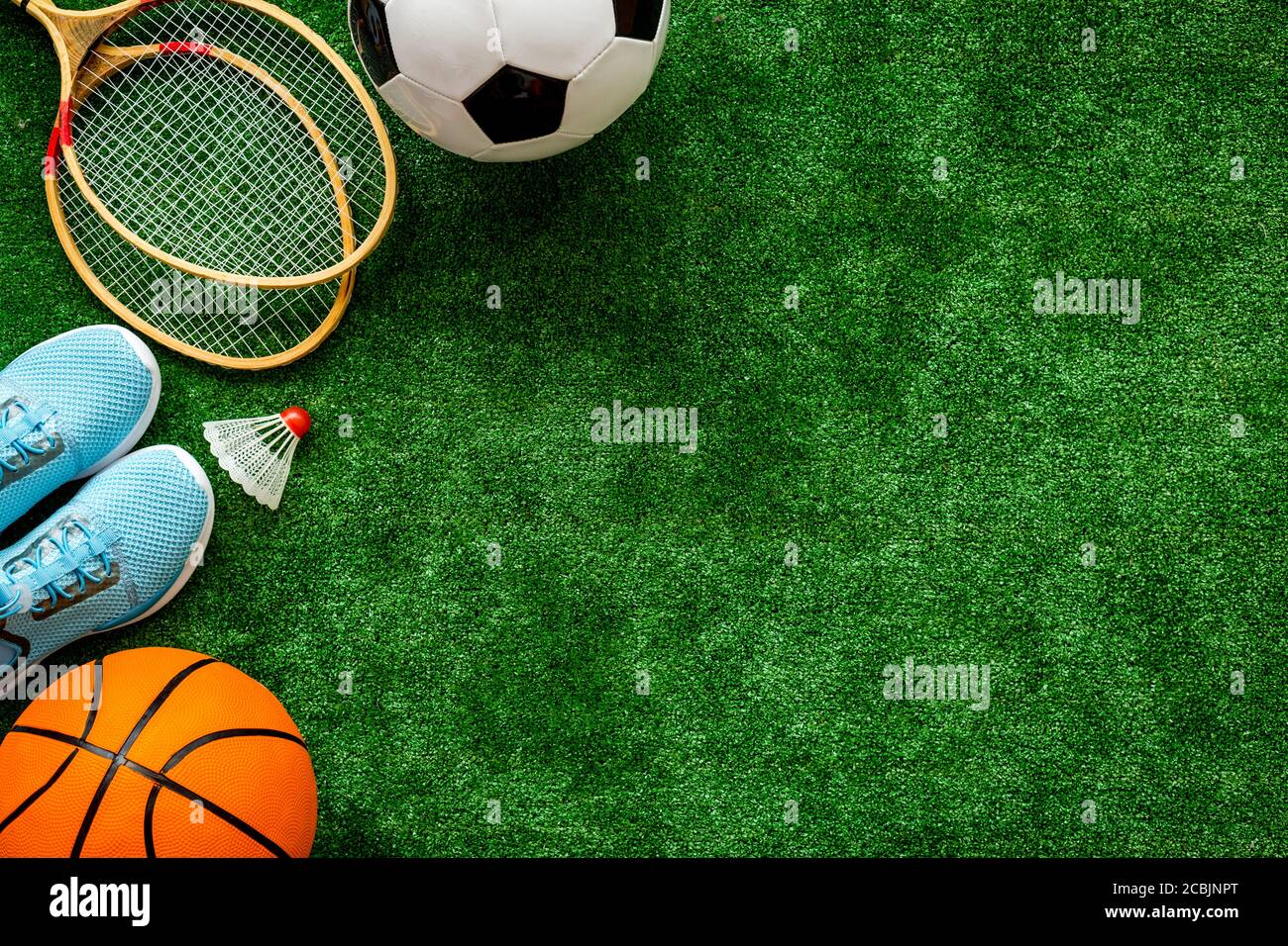 Sport games equipment on football field - balls, sneakers, rackets. Top ...