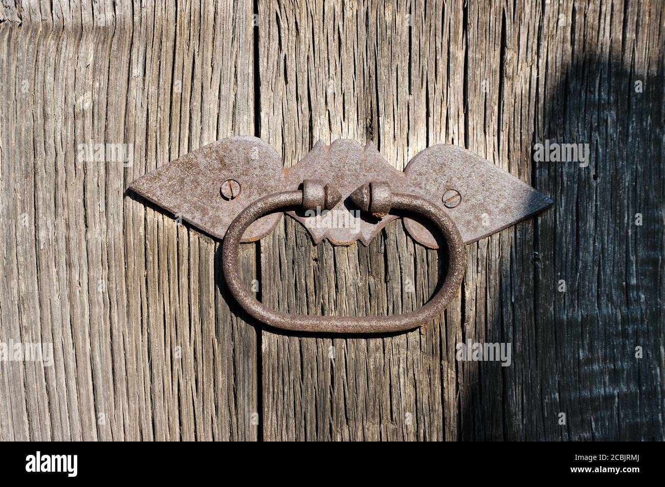 rusty old handle on weathered wooden door Stock Photo - Alamy