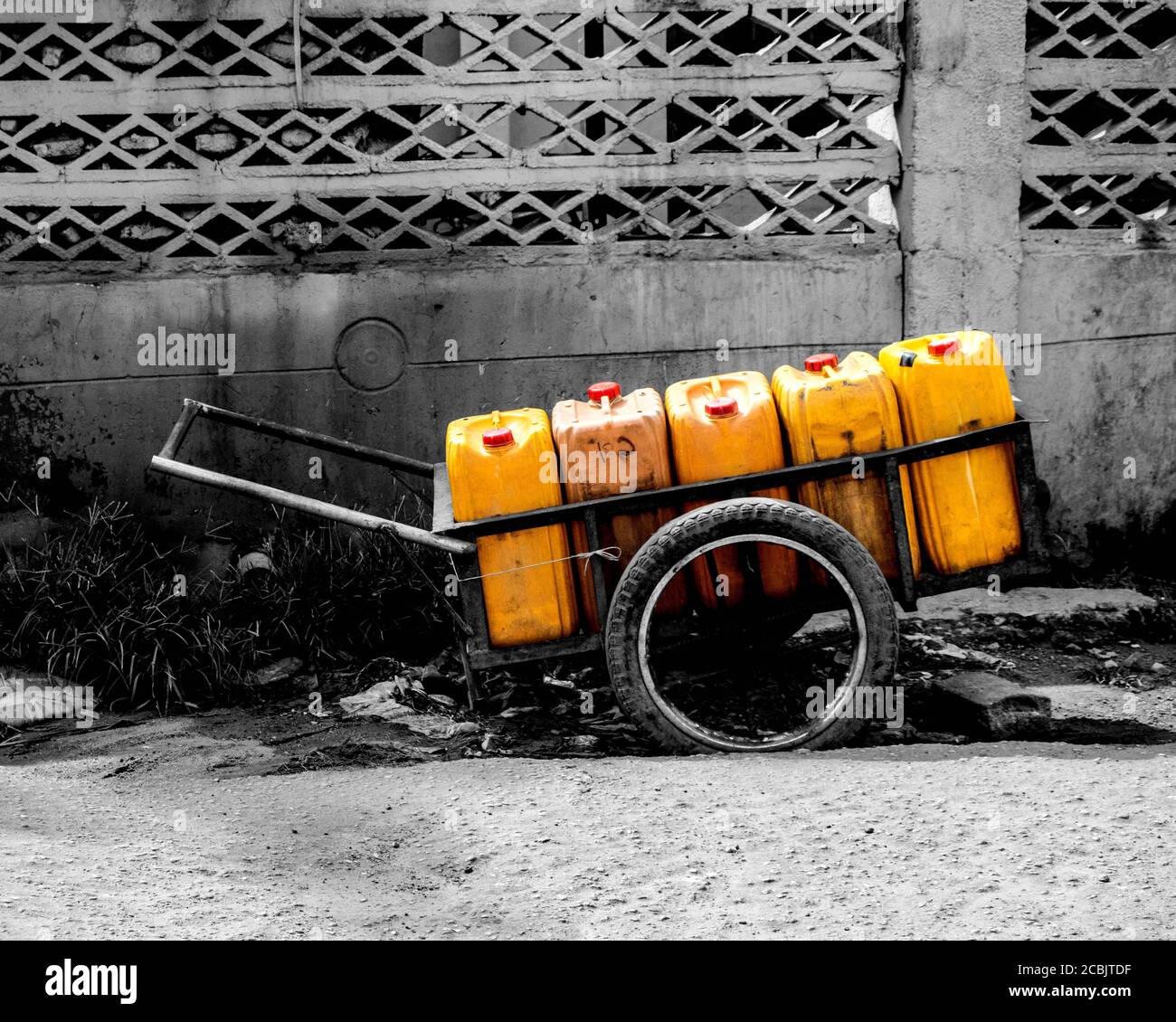 Wheelbarrow carrying water supplies. A modified wheelbarrow carrying ...