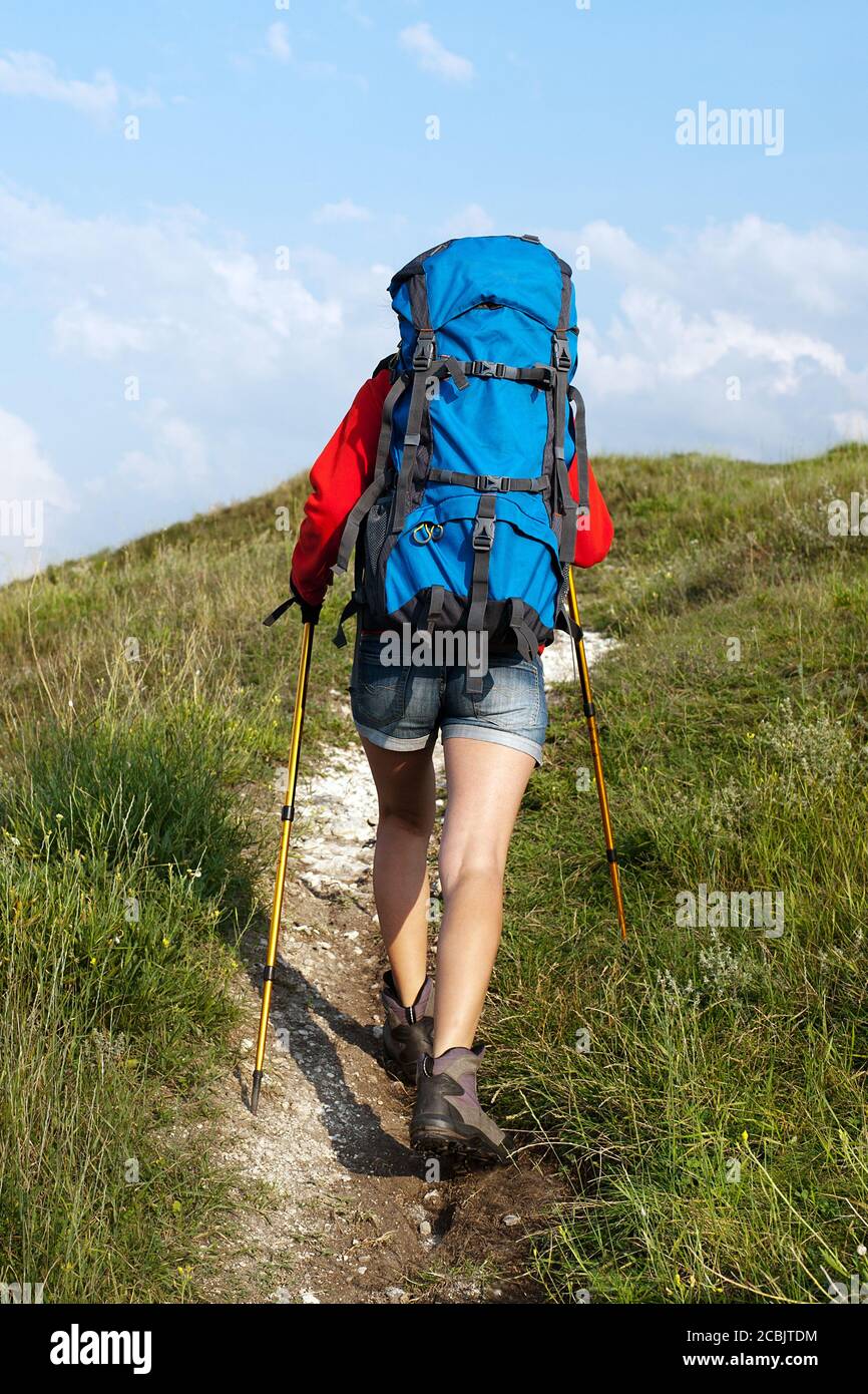 Hiking young woman with backpack Stock Photo - Alamy