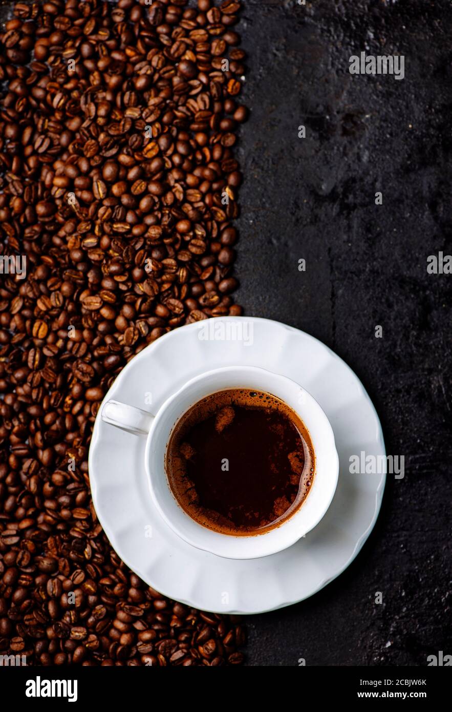 Top view of coffee cup on coffee bean texture and black rustic ...