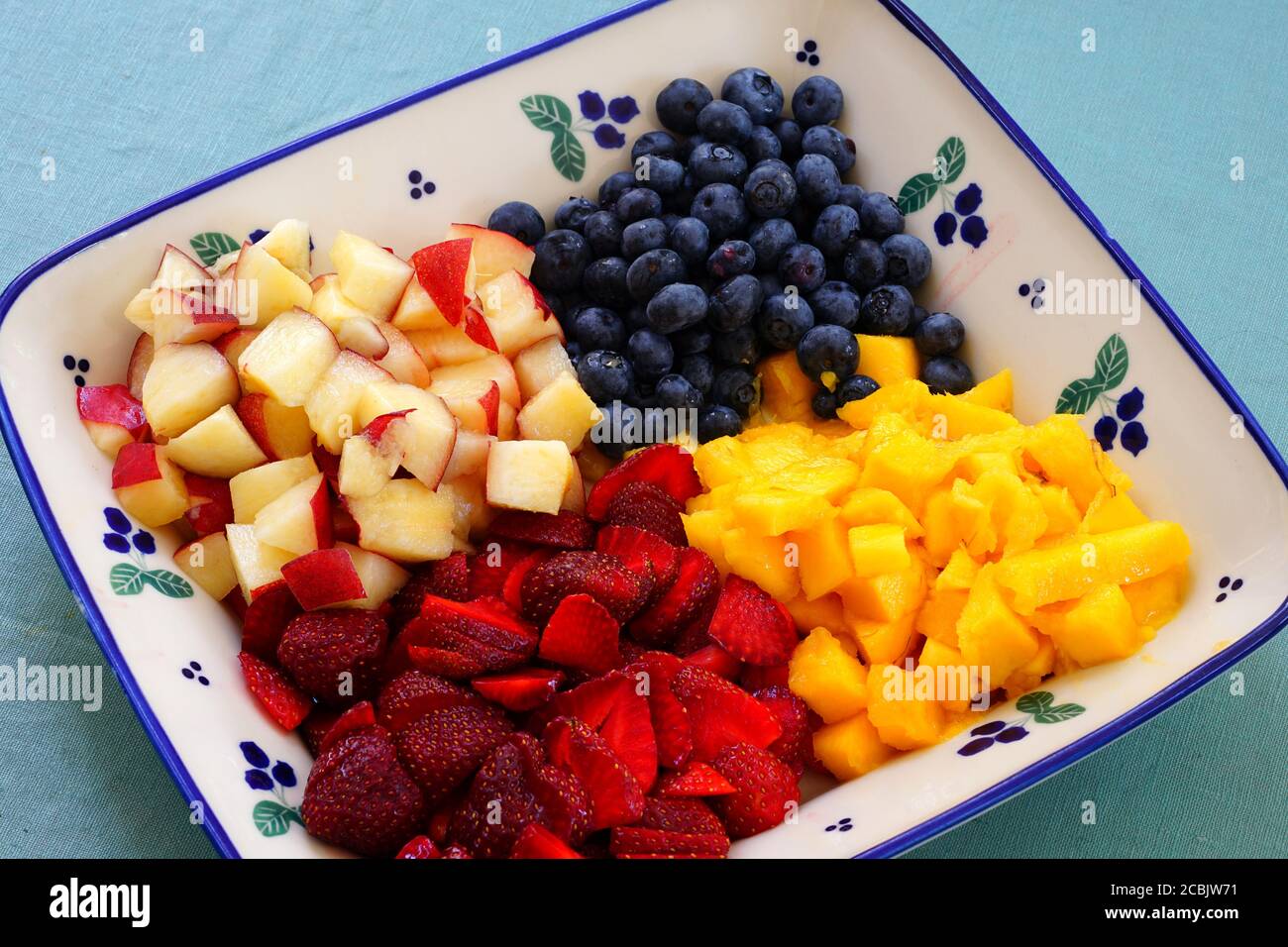 A healthy fruit platter with fresh mango, peaches and berries Stock ...