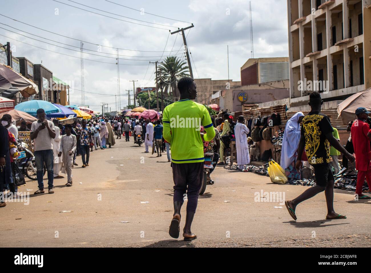 View of a local market. The scene depicts people interacting in a ...