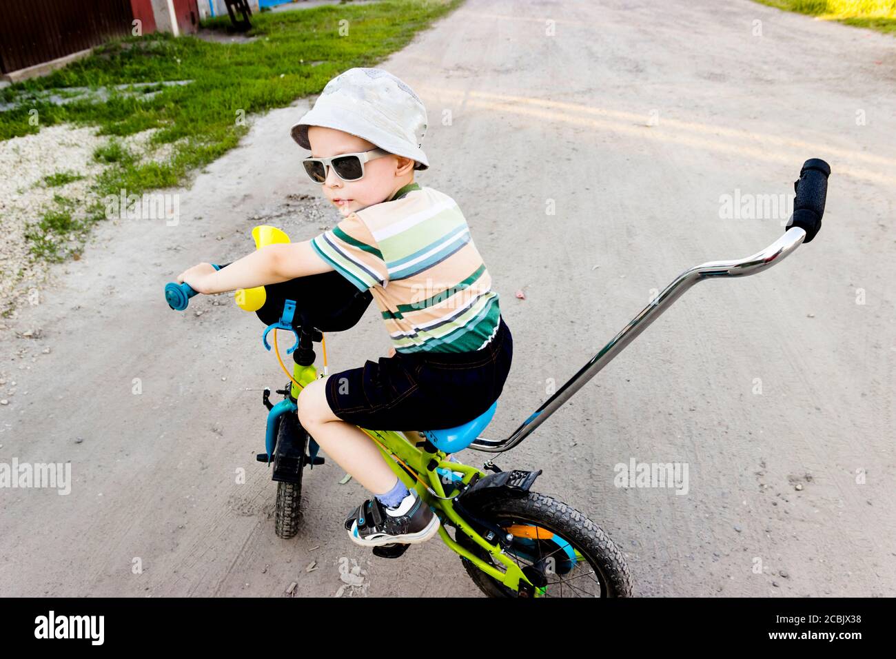 pictured in the photo a little boy is riding a bicycle Stock Photo - Alamy