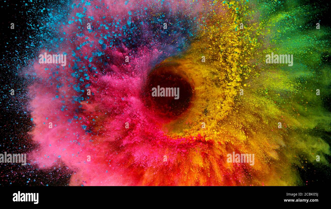 Coloured powder explosion isolated on black background Stock Photo - Alamy