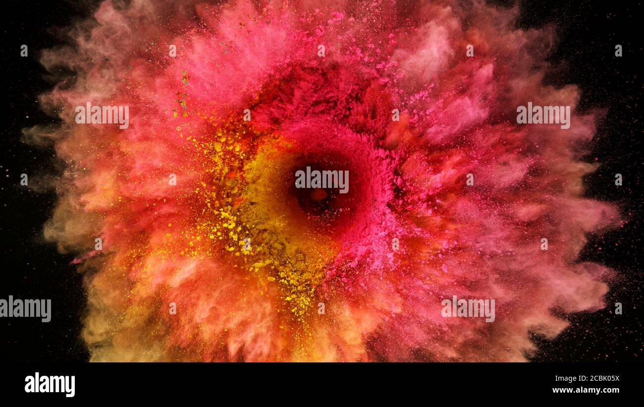 Coloured powder explosion isolated on black background Stock Photo - Alamy
