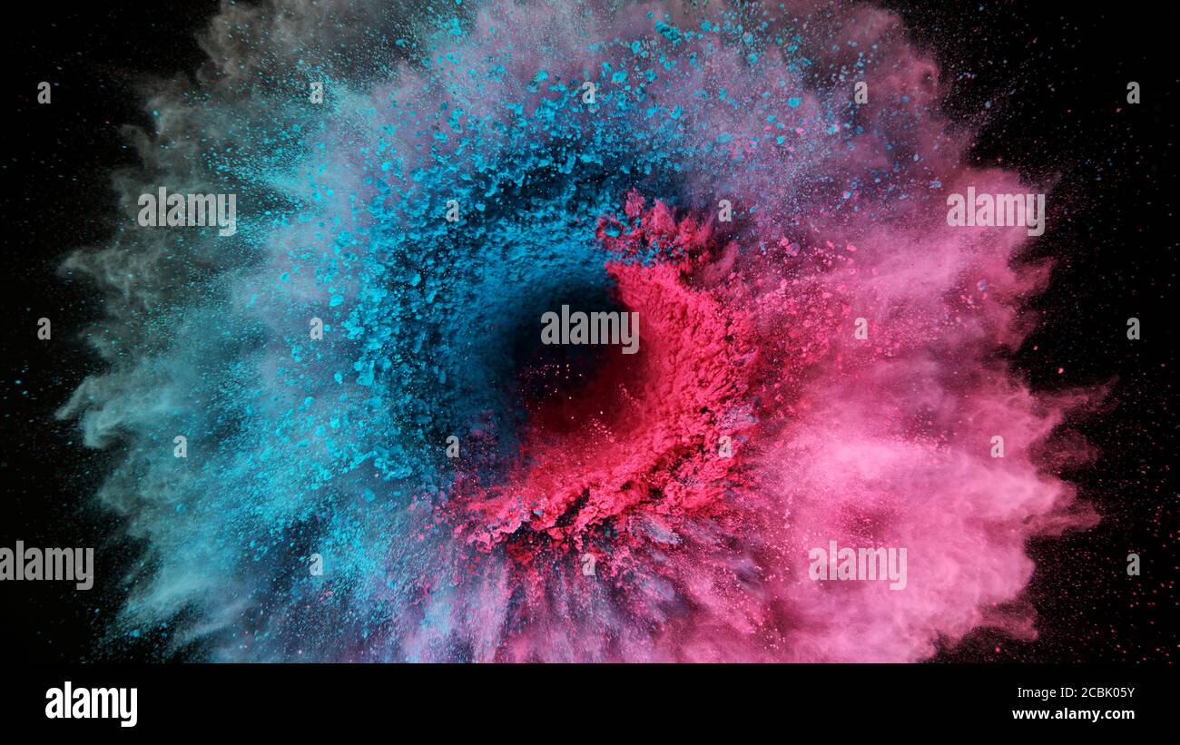 Coloured powder explosion isolated on black background Stock Photo - Alamy