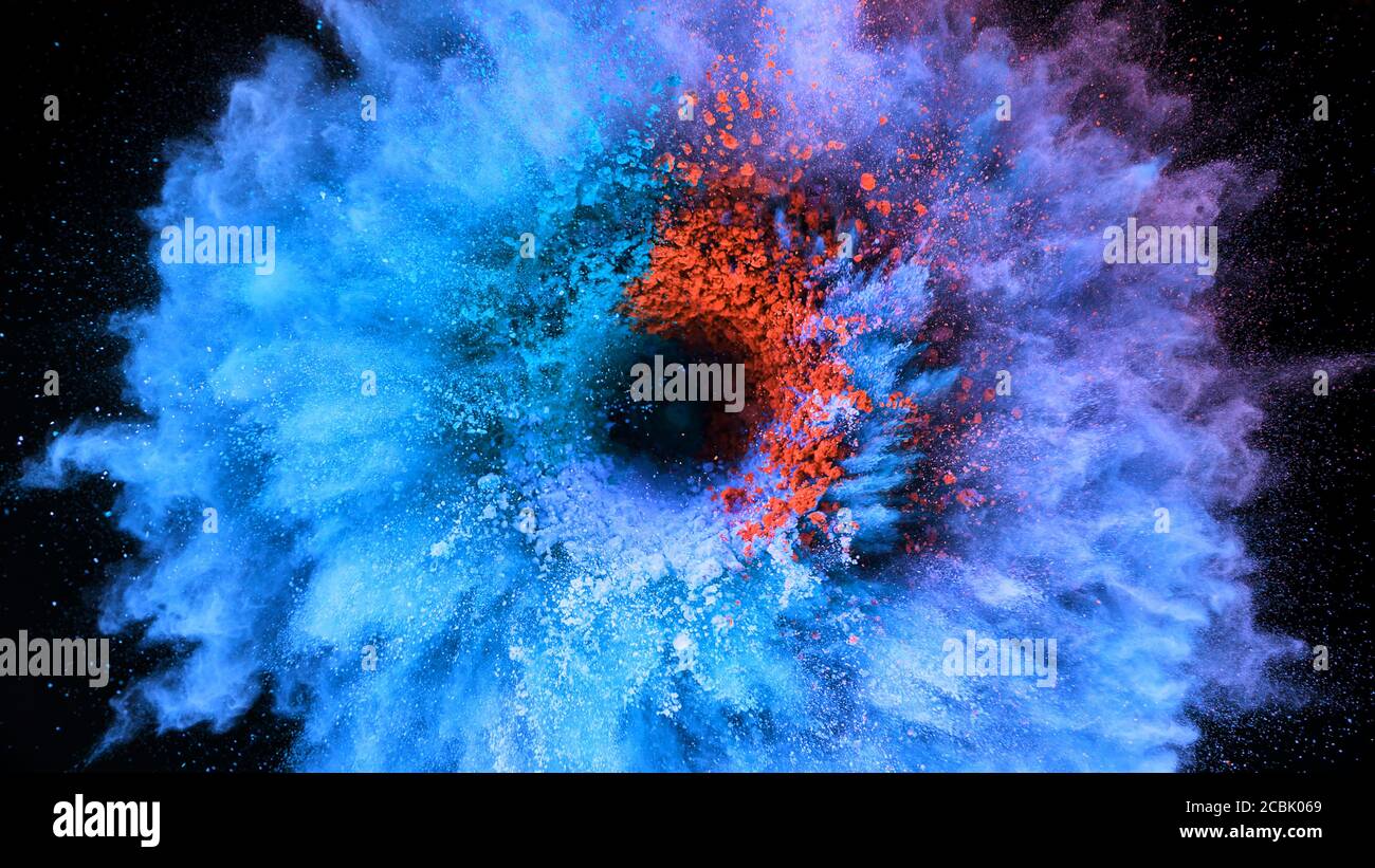 Coloured powder explosion isolated on black background Stock Photo - Alamy