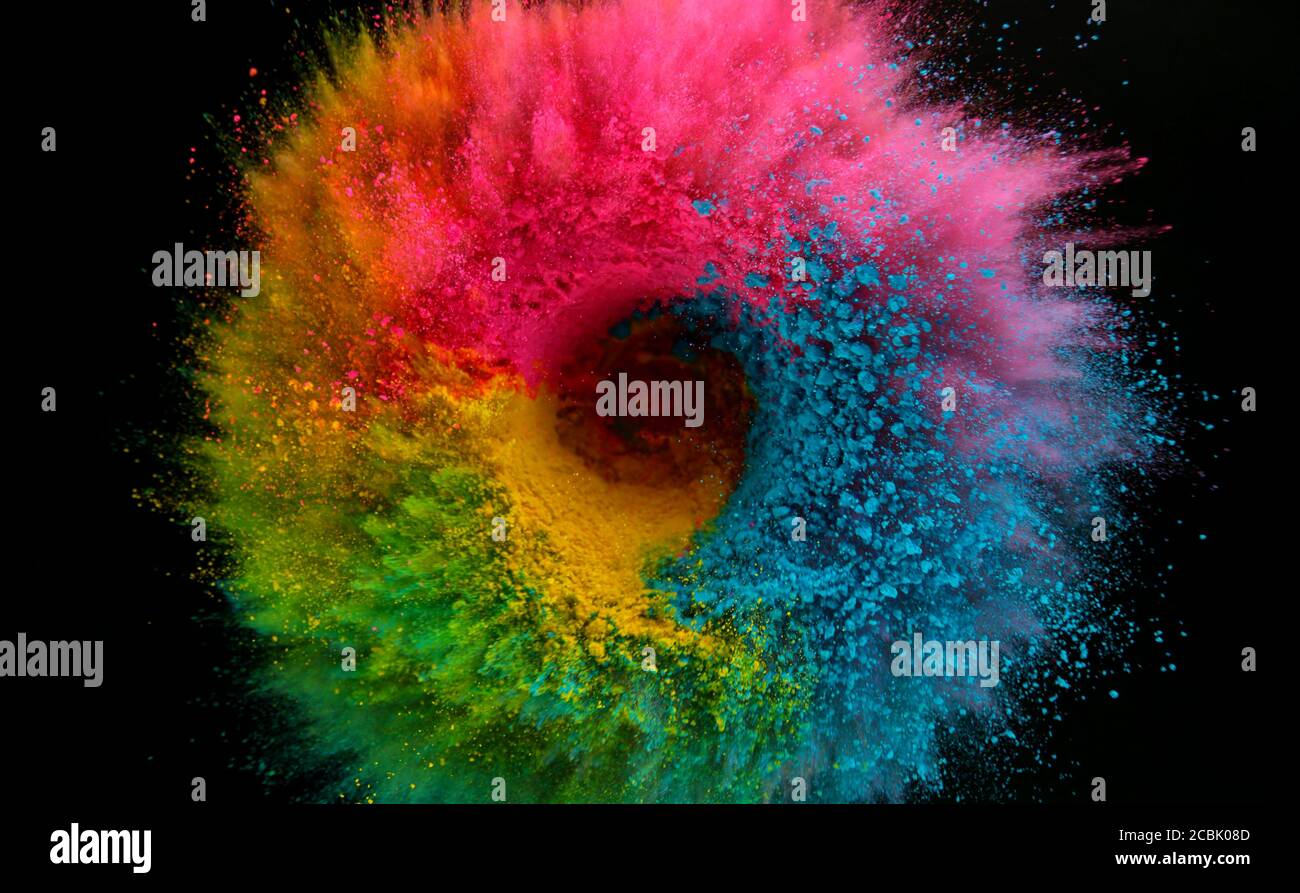 Coloured powder explosion isolated on black background Stock Photo - Alamy