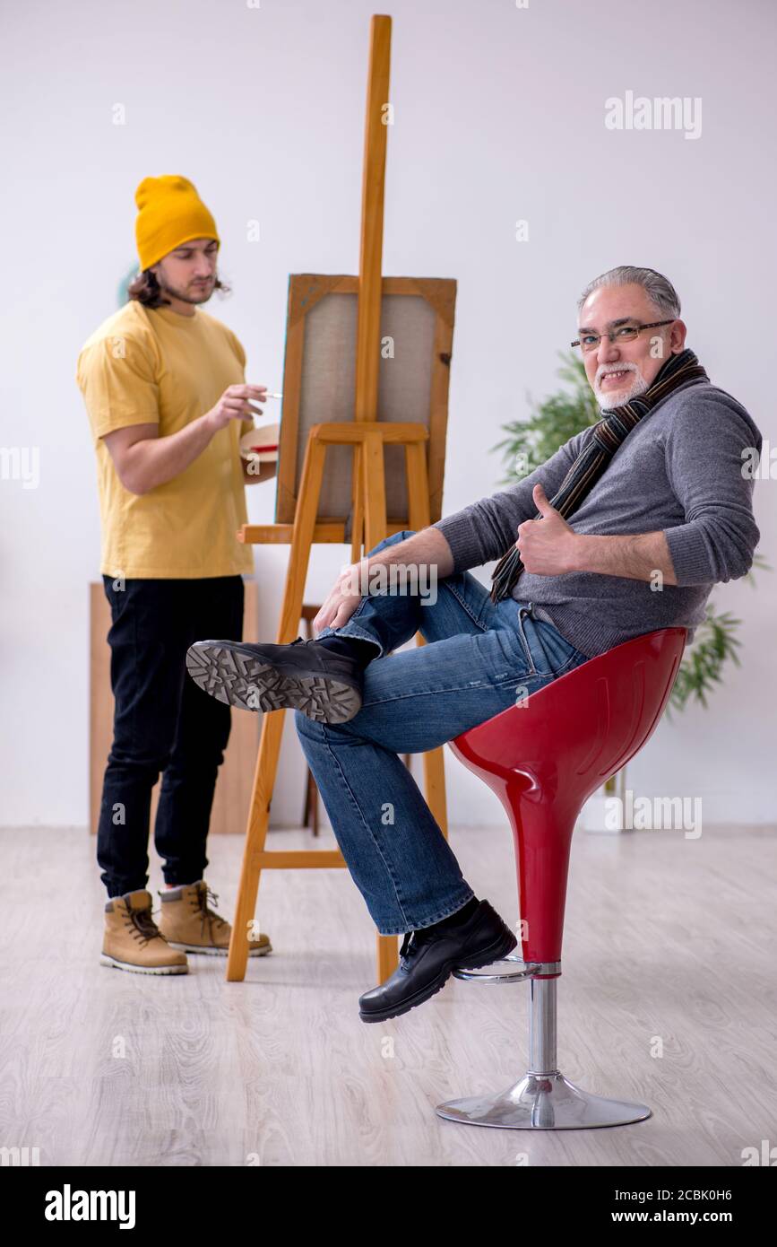 Young portraitist and old model Stock Photo - Alamy