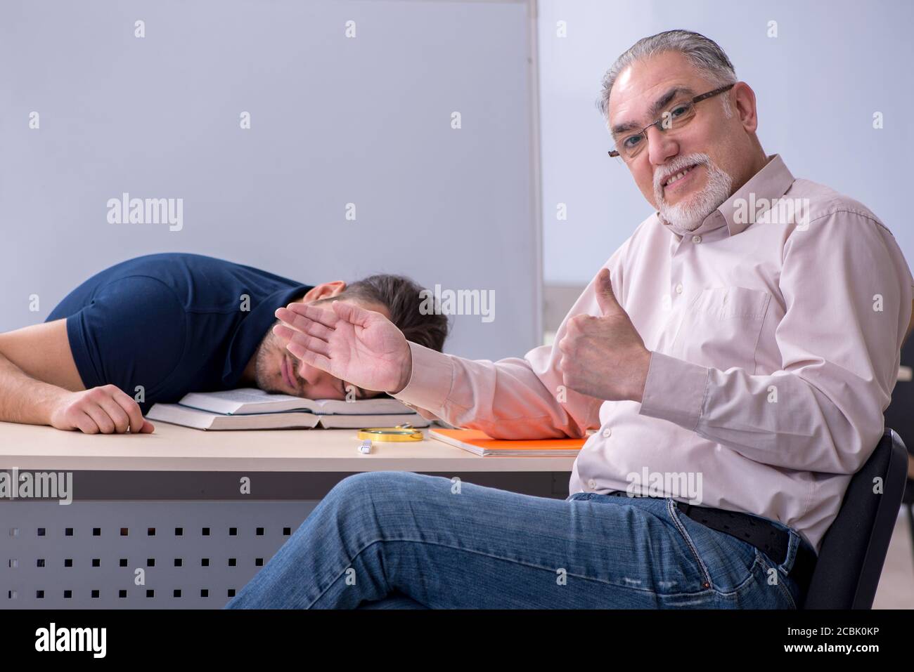 Old teacher and young student in the classroom Stock Photo - Alamy