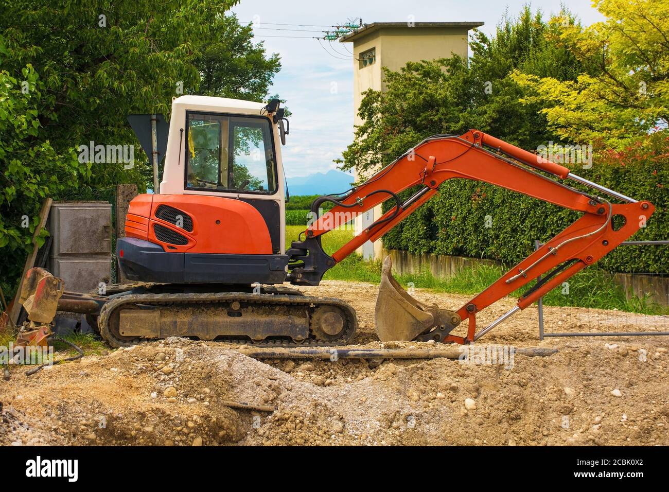 A compact crawler excavator with a rotating house platform and ...