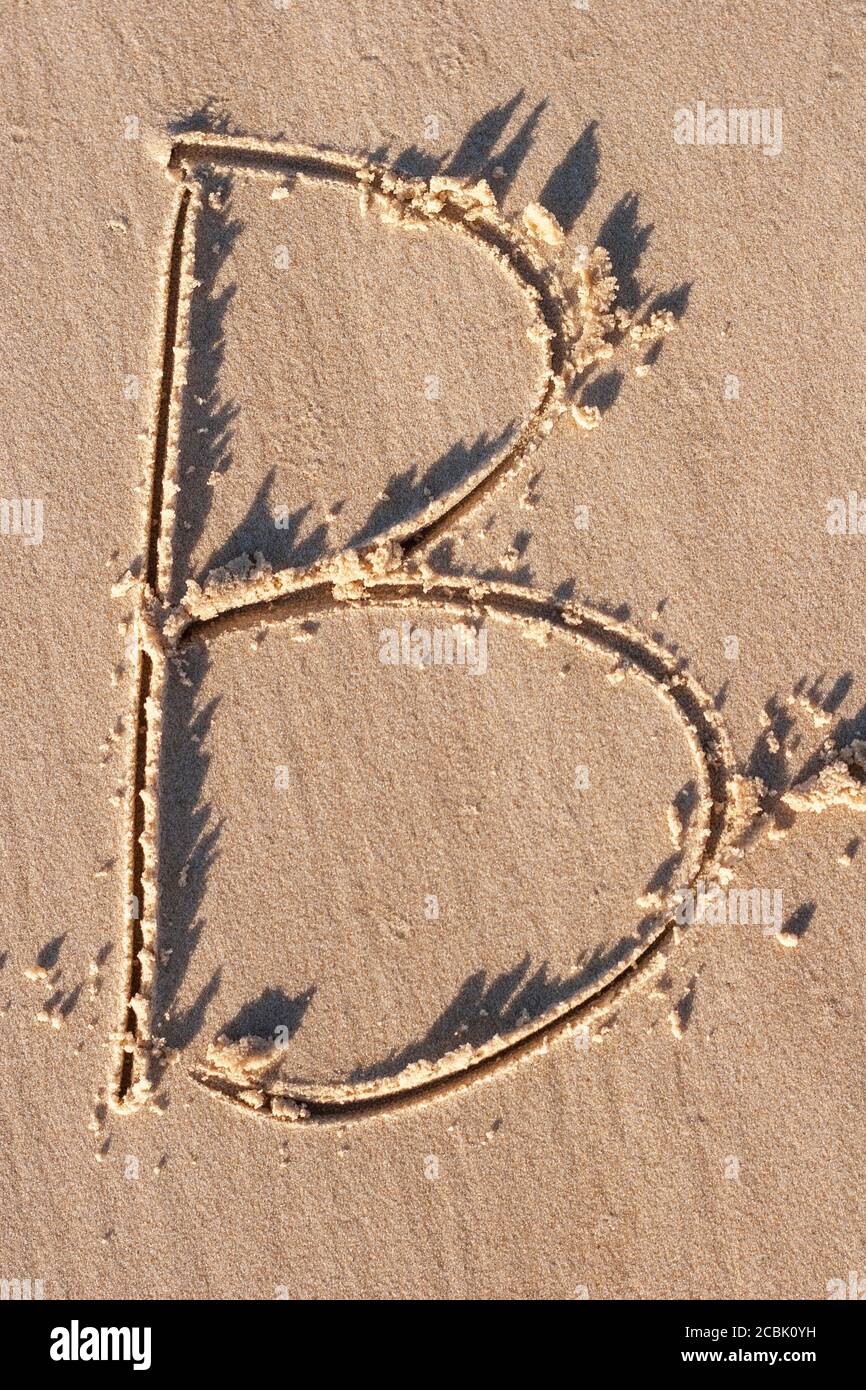 B - Alphabet letter written on sand Stock Photo - Alamy